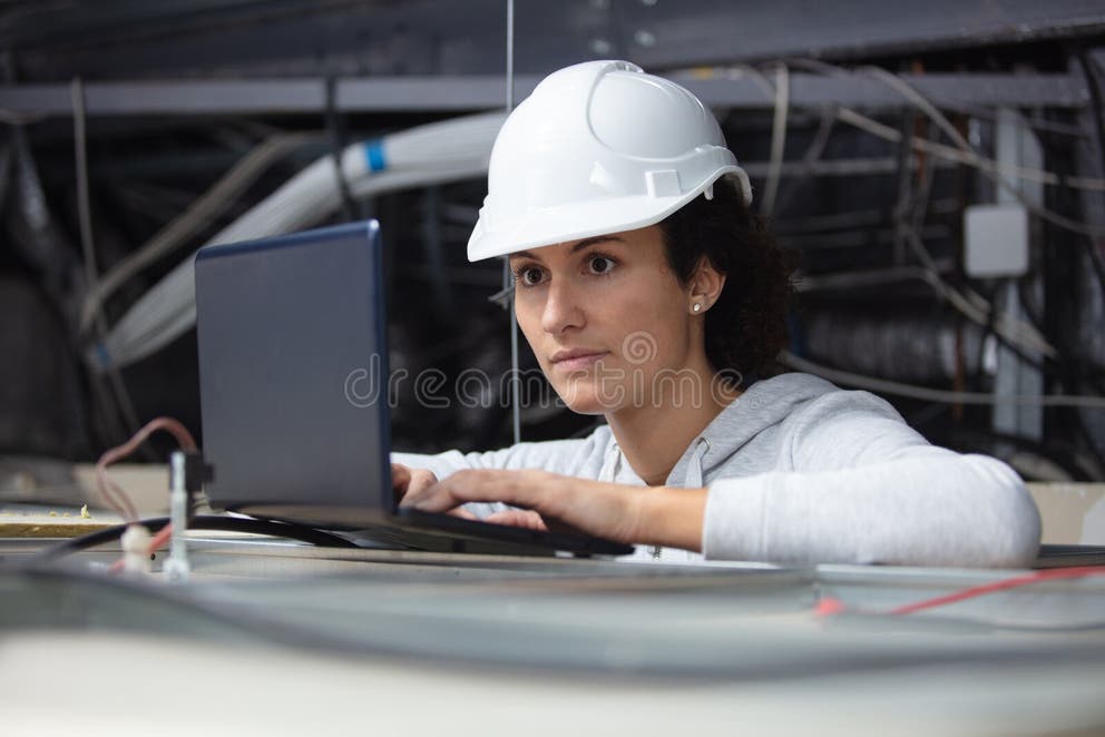 Female Contractor Using Laptop in Roofspace Stock Photo - Image of ...