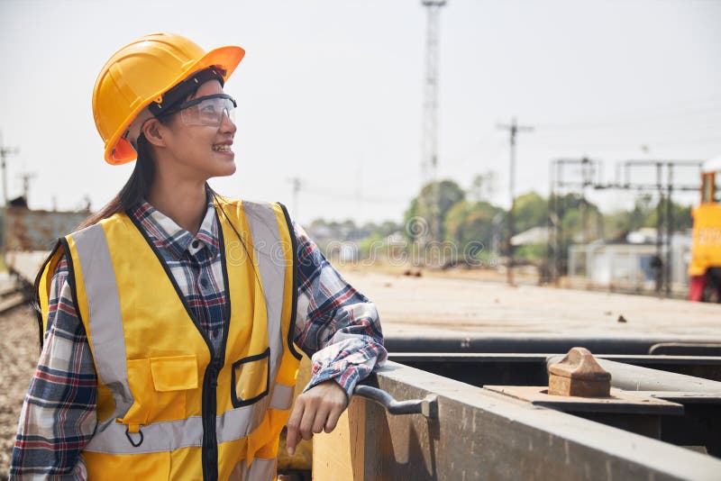 Female Contractor in Yellow Protective Clothing is Standing Outdoors ...
