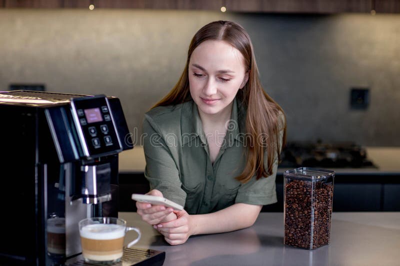 Female Controlling Coffee Machine with Phone at Home. Smart Home ...