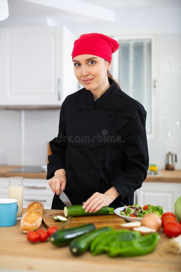 Female Cook in Black Uniform Chopping Vegetables in Kitchen Stock Photo ...