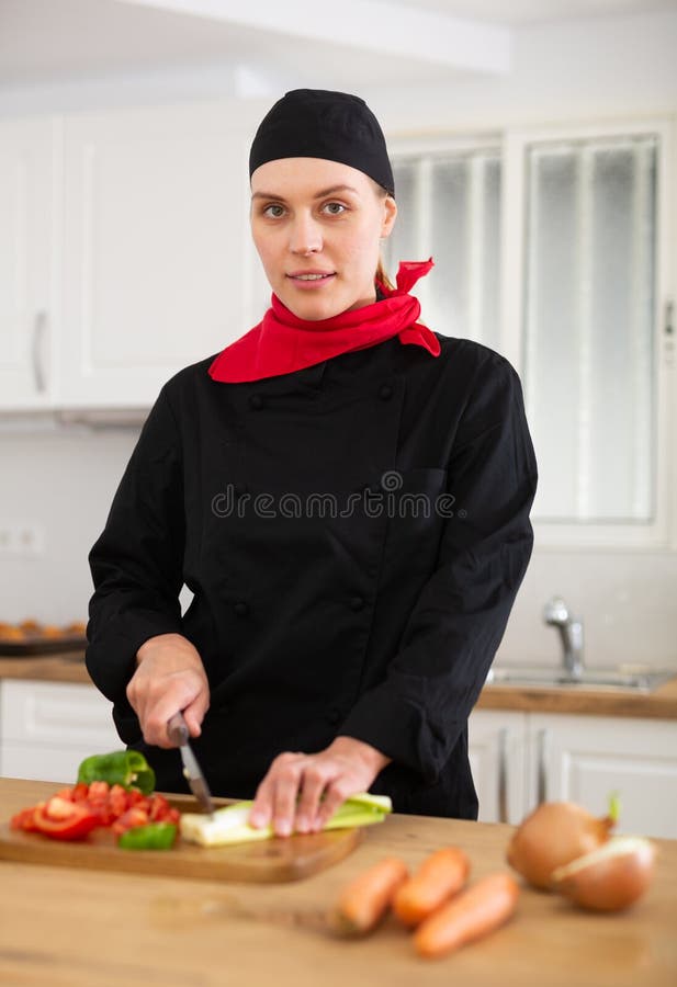 Female Cook in Black Uniform Chopping Vegetables in Kitchen Stock Photo ...