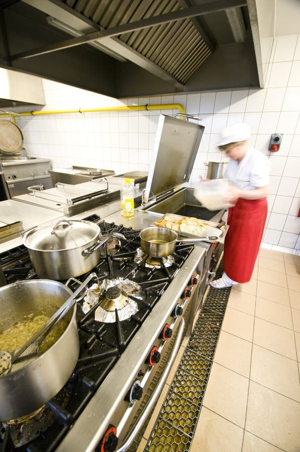 Cook in industrial kitchen stock photo. Image of interior - 34864862