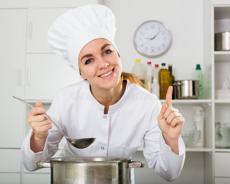 Female cook tasting food stock image. Image of process - 233037851