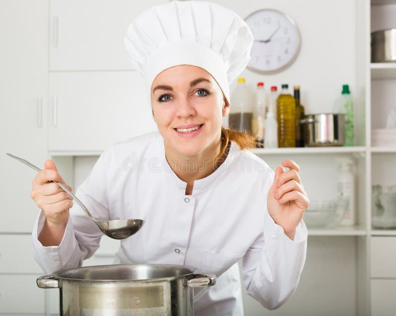 Female cook tasting food stock image. Image of checking - 205945937