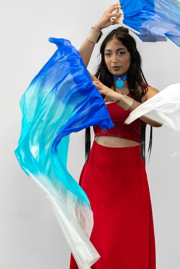 Female Cosplayer in a Red Dress Waving and Dancing with a Blue ...