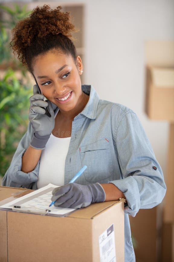 Female Courier on Smartphone Making Notes on Paperwork Stock Image ...