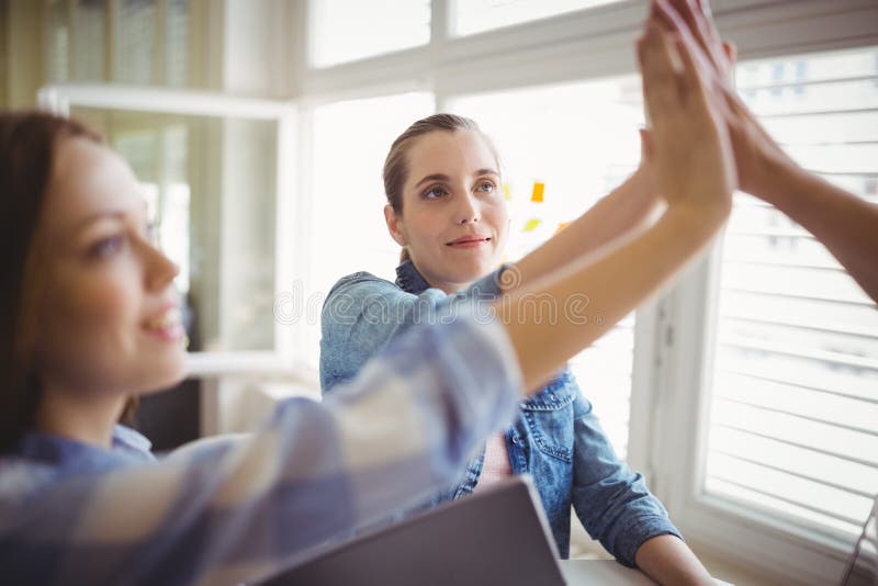 Female Coworkers Giving High-five in Creative Office Stock Image ...