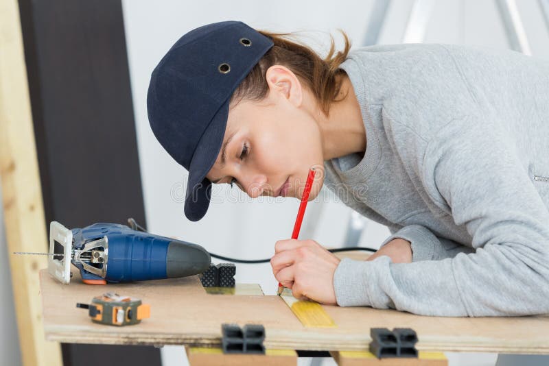 Female Crafter Measuring Wood Jigsaw on Workbench Stock Image - Image ...