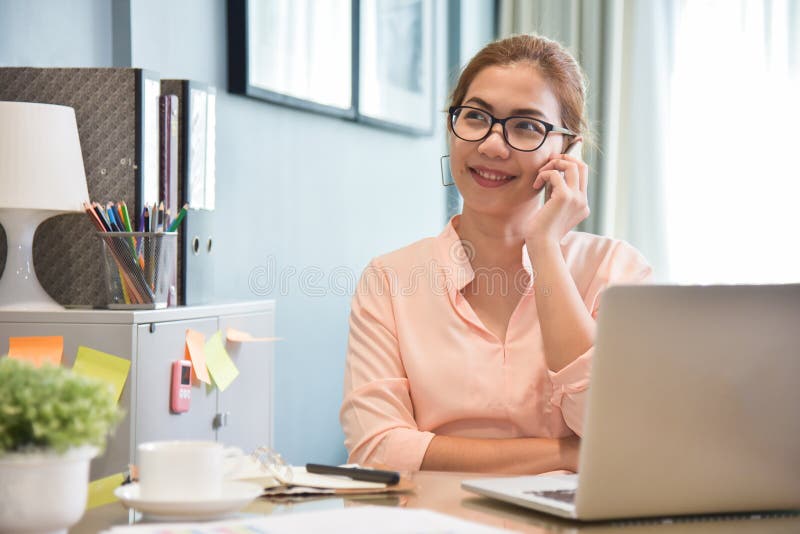 Female Creative Designer Talking on Cell Phone at Her Workplace. Stock ...