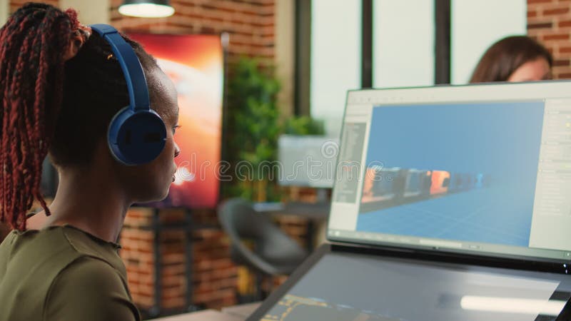 Female Creative Engineer Using Game Programming Software Stock Photo ...