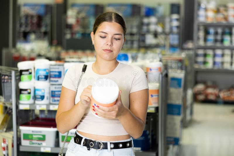 Female Customer Chooses Can of Paint in Hardware Store Stock Image ...
