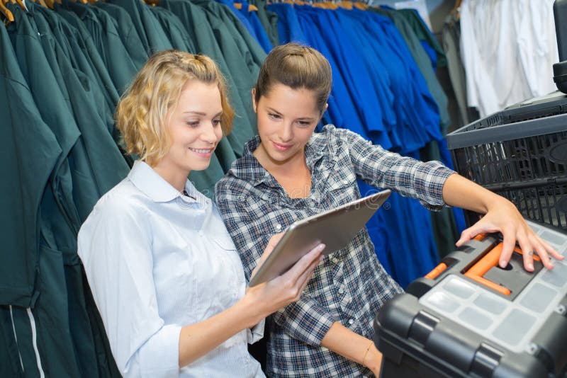 Female Customer Choosing Right Uniform Stock Photo - Image of retail ...