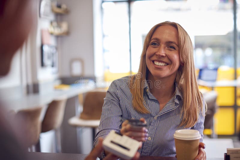 Female Customer Making Contactless Payment in Coffee Shop Using Debit ...