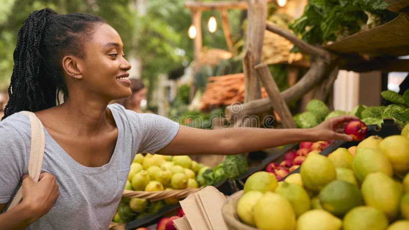 Female Customer at Market Stall Choosing Fresh Fruit and Vegetables ...