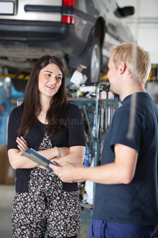 Female Customer in Mechanic Shop Stock Photo - Image of communication ...