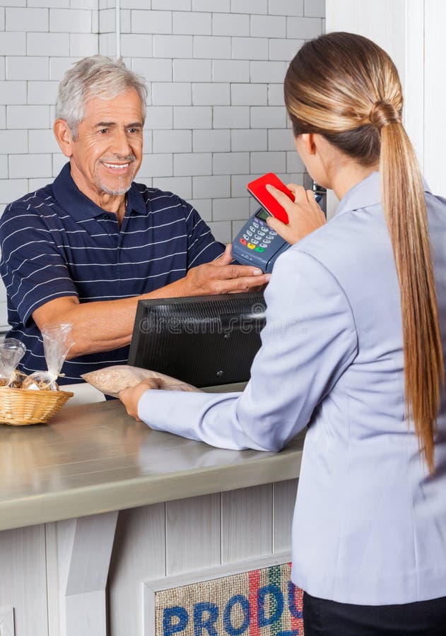 Customer Paying through Mobile Phone in Store Stock Photo - Image of ...