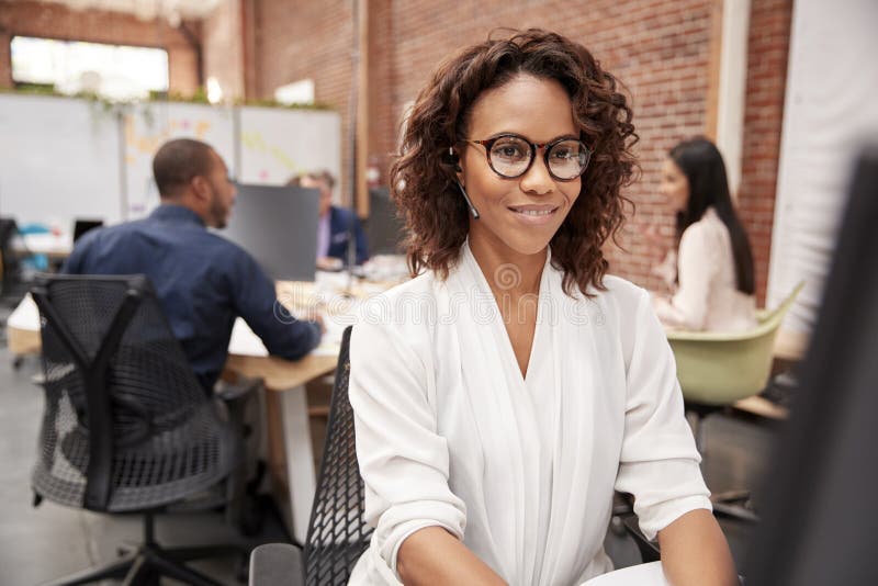 Female Customer Services Agent Working at Desk in Call Center Stock ...