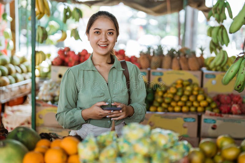 Female Customer Smiling while Standing and Holding the Phone Stock ...
