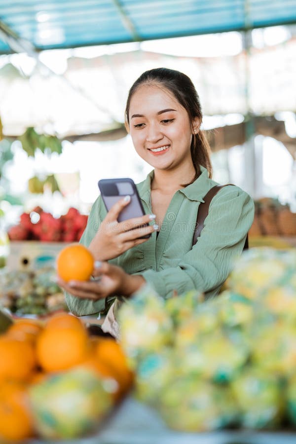 Female Customer Smiling while Taking Photo of the Mandarin Fruit Stock ...
