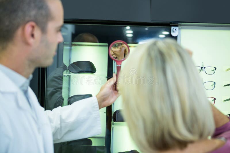 Female Customer Wearing Spectacles and Checking in Mirror Stock Photo ...