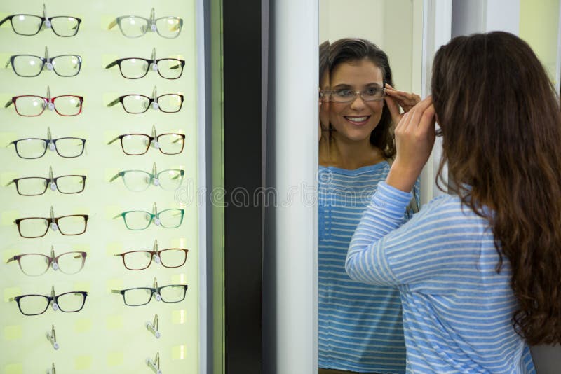 Female Customer Wearing Spectacles and Checking in Mirror Stock Image ...