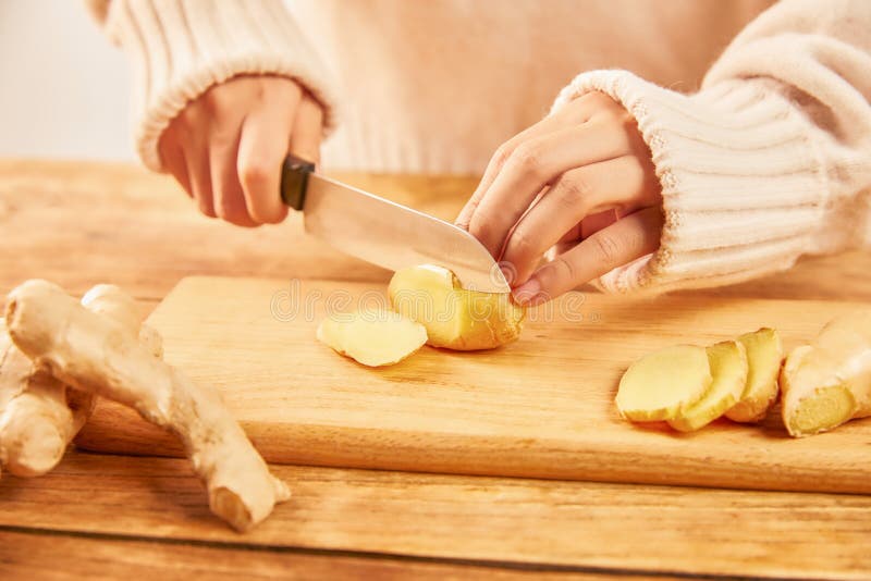 Female Cutting a Ginger on a Chopping Board Stock Photo - Image of ...