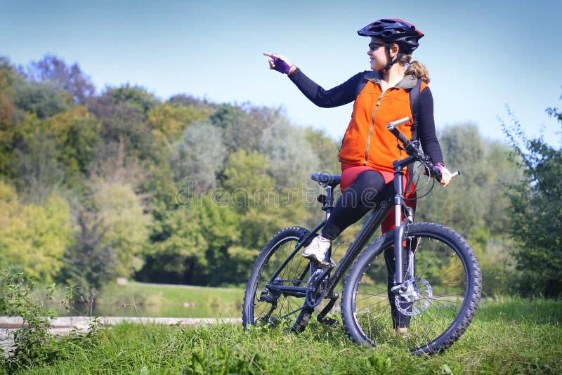 Female Cyclist Pointing Lake Stock Photos - Free & Royalty-Free Stock ...