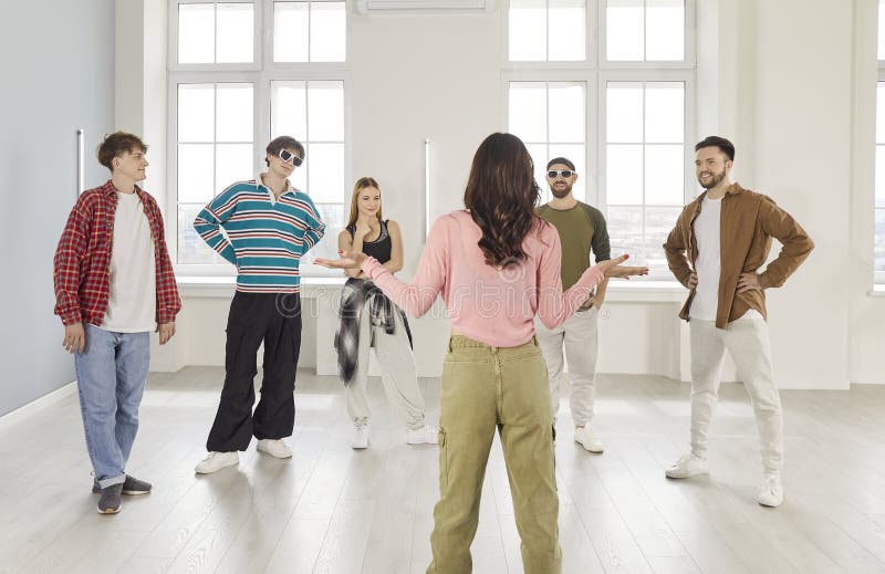 Female Dance Instructor Leading Group of Young People in Studio during Hip Hop Choreography ...