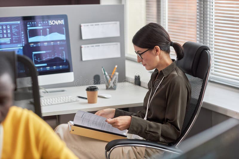 Female Data Scientist Working with Documentation at Desk in Office ...