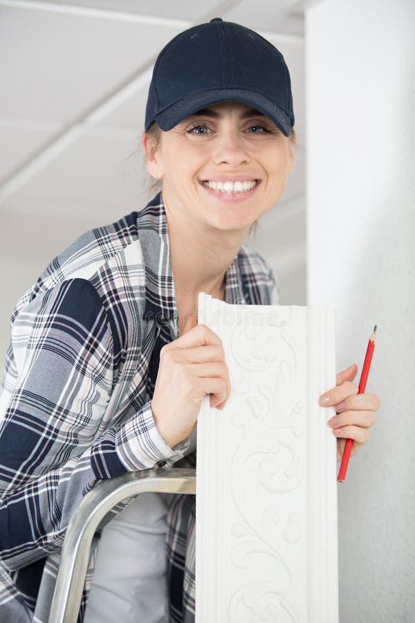 Female Decorator Holding Length Decorative Coving Stock Photo - Image ...