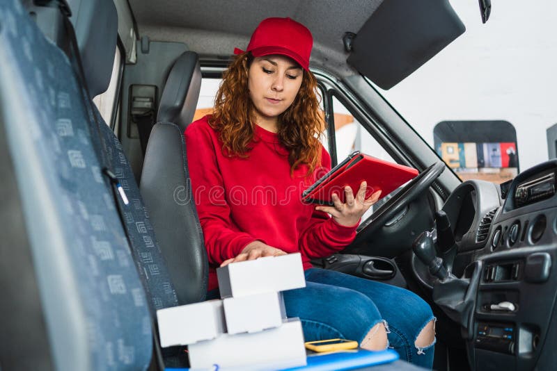 Female Delivery Driver Organizing Packages in the Van Stock Photo ...