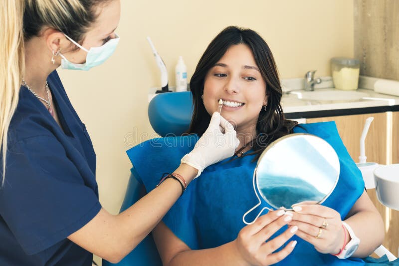 Female Dentist Holding Color Samples Choosing a Shade for a Her Patient ...