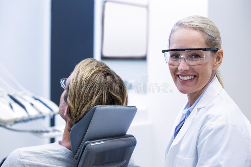Female dentist smiling stock image. Image of examination - 75190865