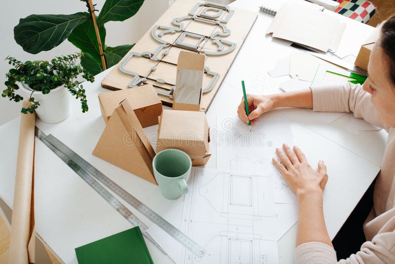 Female Designer Drawing Schematics Behind a Table Stock Photo - Image ...
