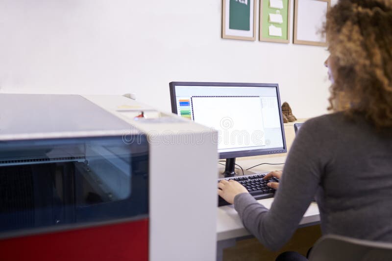 Female Designer Operating CAD System for Laser Cutter Stock Photo ...