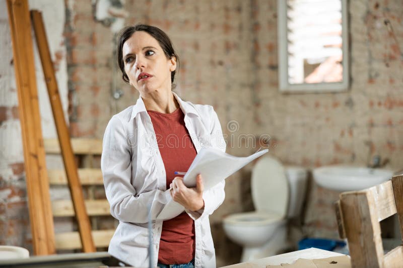 Female Designer with Papers Working in Apartment Under Renovation Stock ...