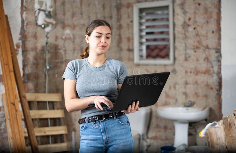 Female Designer Using Laptop in Apartment during Repair Works Stock Image - Image of person ...