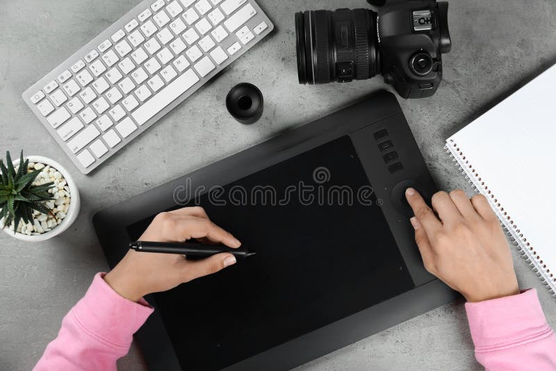 Female Designer Working with Graphic Tablet at Grey Stone Table Stock ...