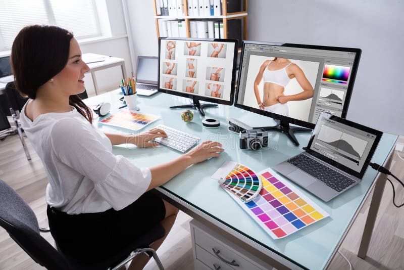 Female Designer Working with Photographs on Multiple Computer Stock ...