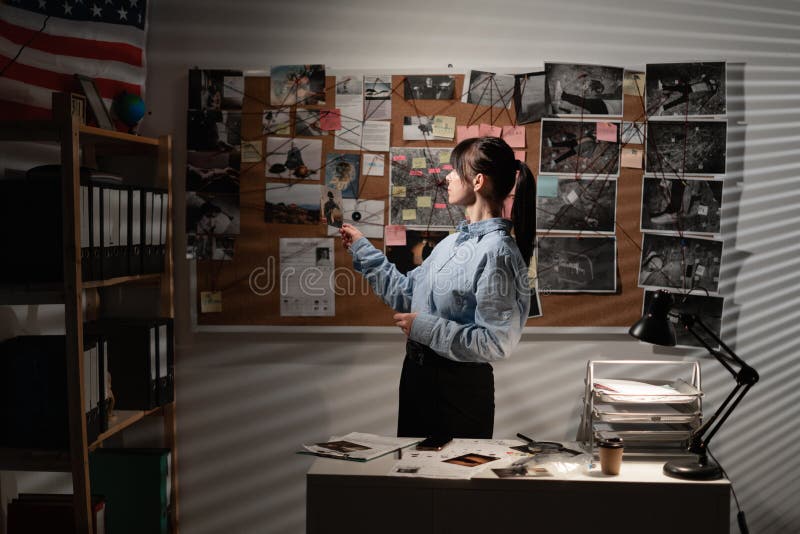 Female Detective Working in Her Office with Evidence. Stock Photo ...