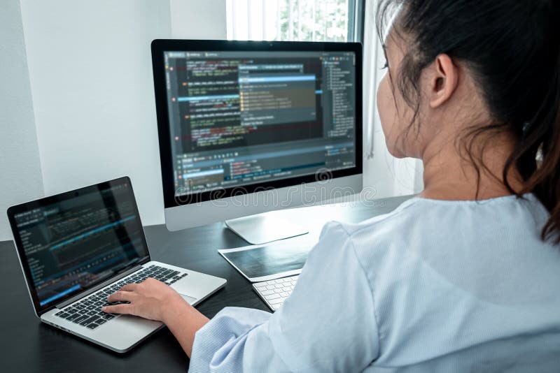 Female Web-developer Posing With Smile In Office While Her Asian Male Colleague Working On ...