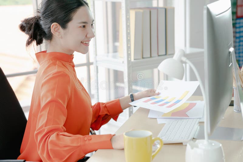 A Female Director Working in Office Sitting at Desk Analyzing Business ...