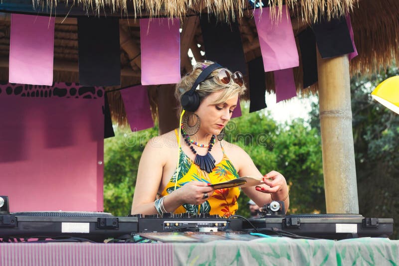 A Female DJ Using Mixing Decks with Old-fashioned Vinyl Records ...