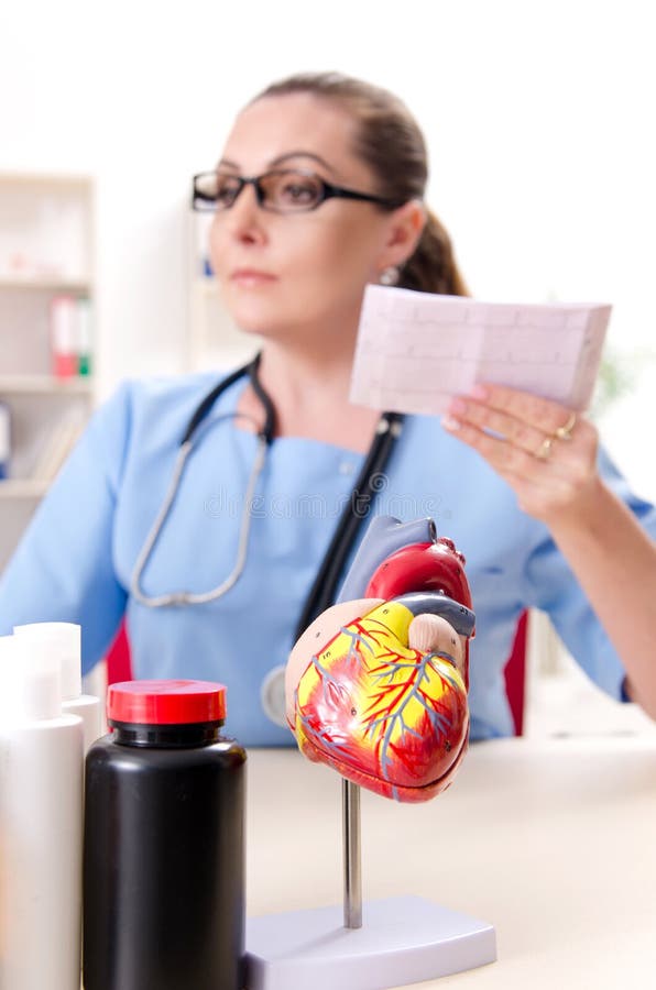 The Female Doctor Cardiologist Working in the Clinic Stock Image ...