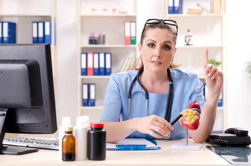 The Female Doctor Cardiologist Working in the Clinic Stock Photo ...
