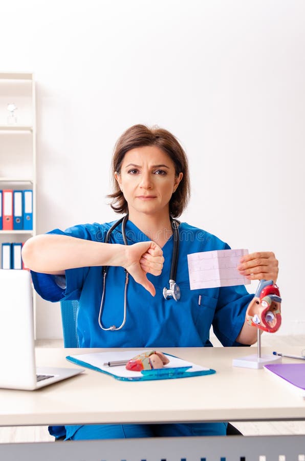 The Female Doctor Cardiologist Working in the Hospital Stock Photo ...