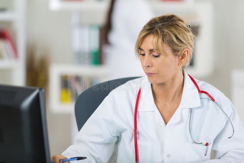Female Doctor Checking Computer Stock Photo - Image of female ...