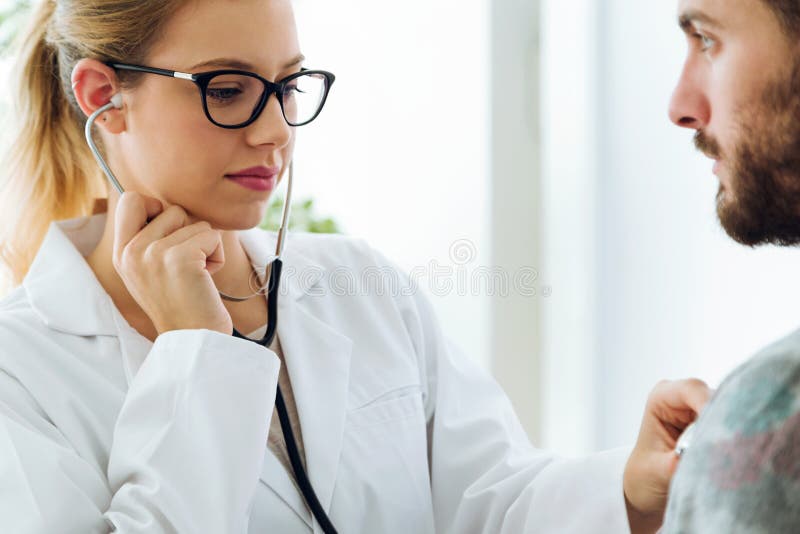 Female Doctor Checking Patient Heartbeat Using Stethoscope. Stock Photo ...