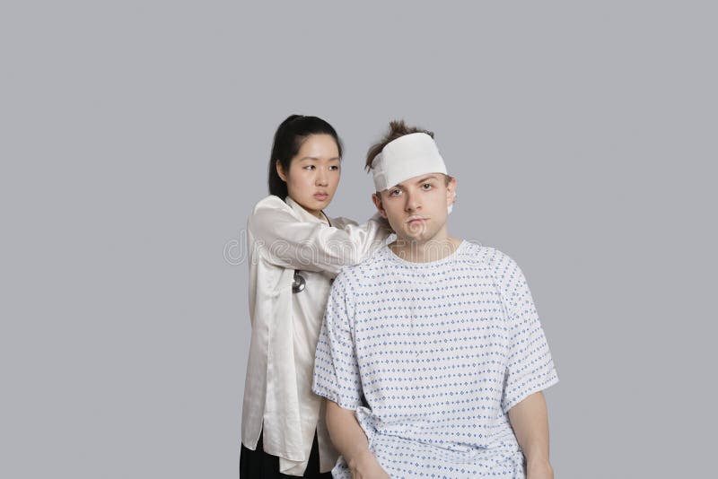 Female Doctor Dressing Patient S Head with Bandage Stock Image - Image ...