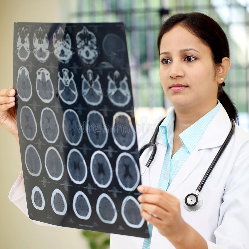 Female Doctor Examining a Brain Tomography Scan Stock Image - Image of ...